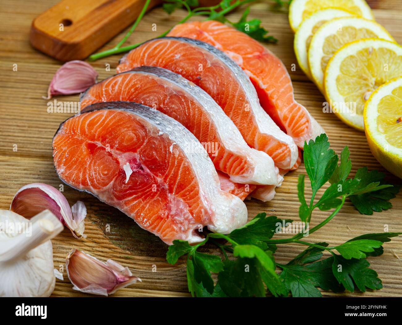 Raw salmon fillet on wooden table with cooking ingredients Stock Photo ...