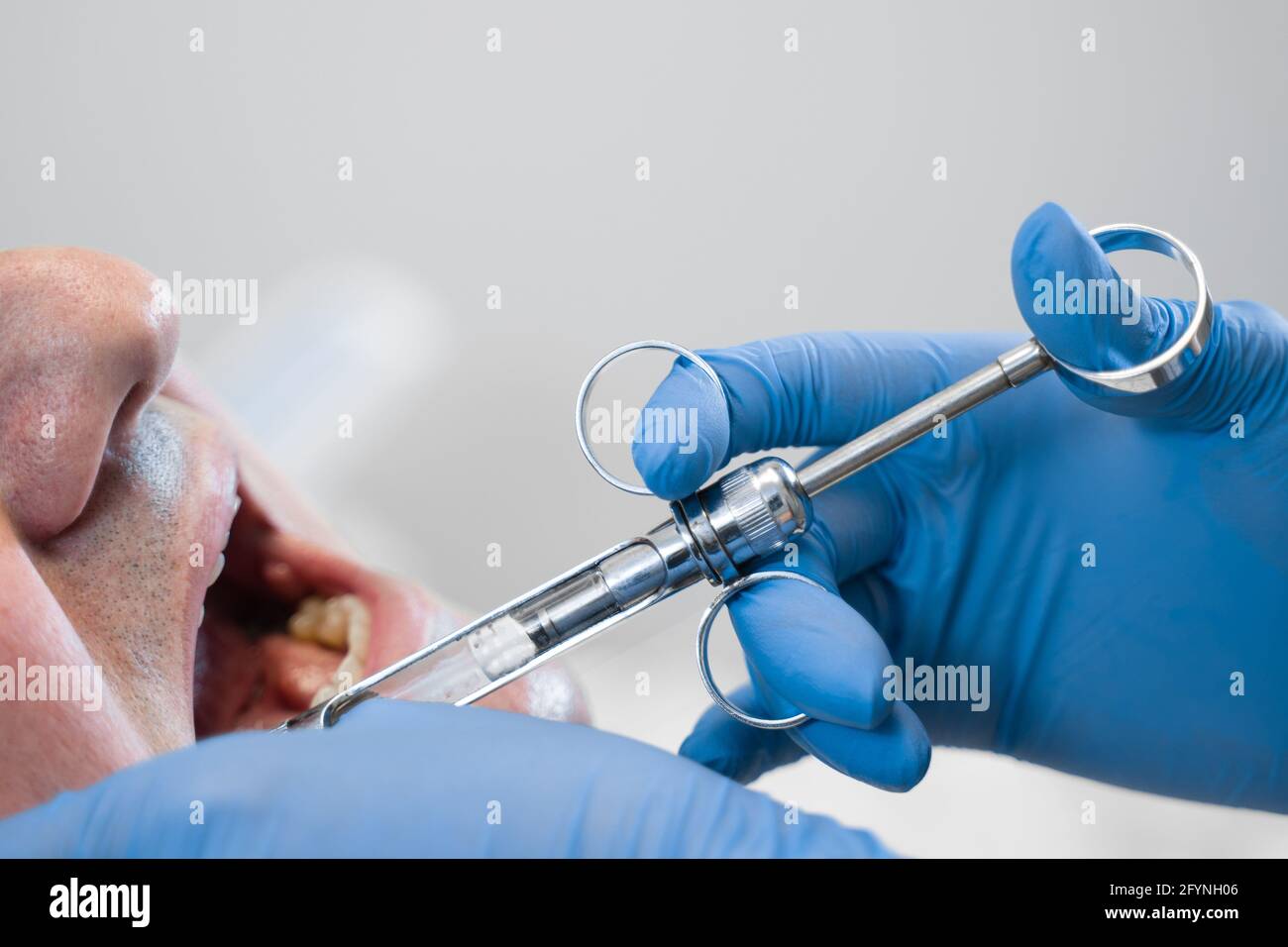 Dentist injects anesthesia syringe of the diseased teeth for the ...