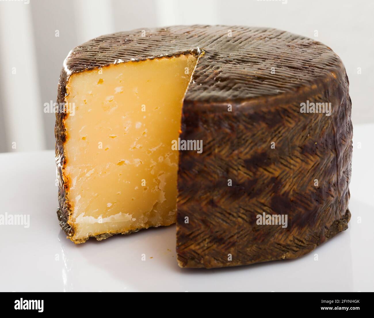 Spanish manchego cheese on a white surface Stock Photo - Alamy