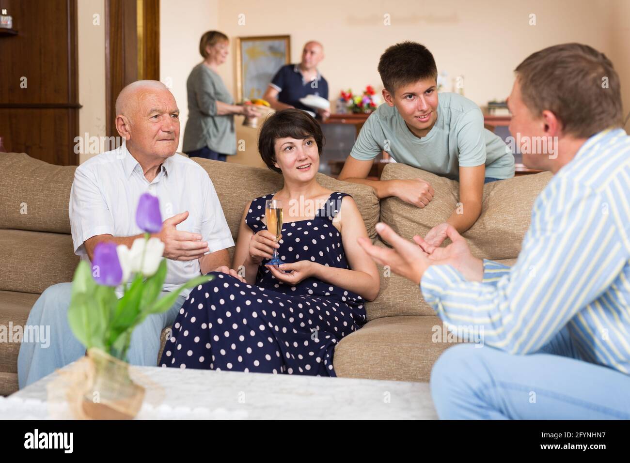 Portrait of happy family with grandparents together in living room ...