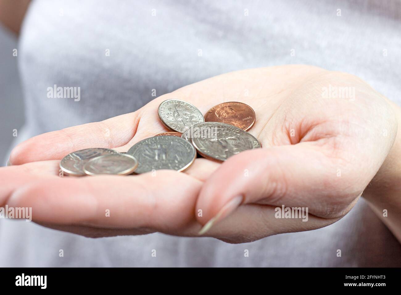Caucasian woman hands holding and counting usa coin cents. Unemployment ...