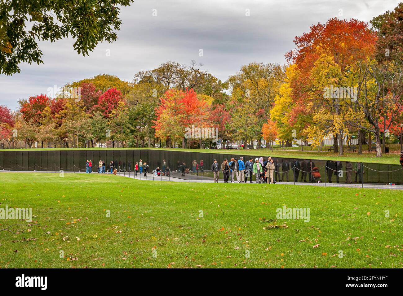 People looking at names engraved on The Vietnam Memorial wall which ...