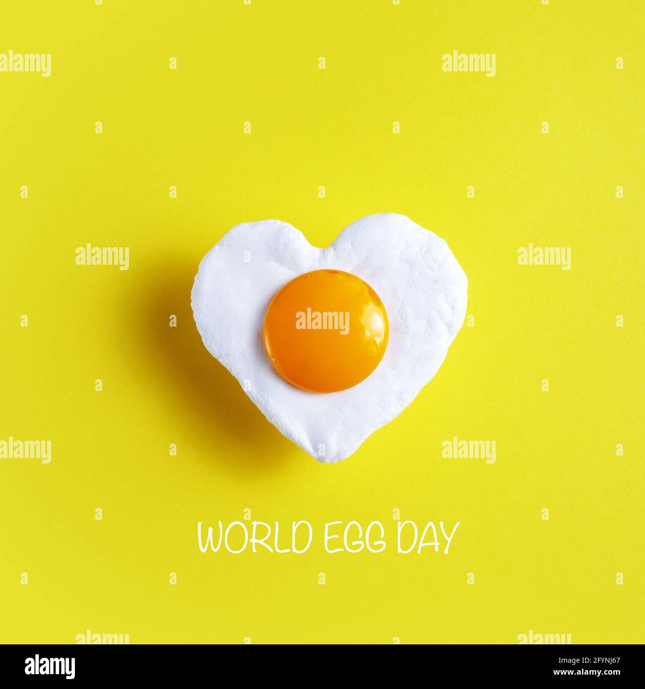 Heart shaped egg on yellow background, for the world egg day Stock ...