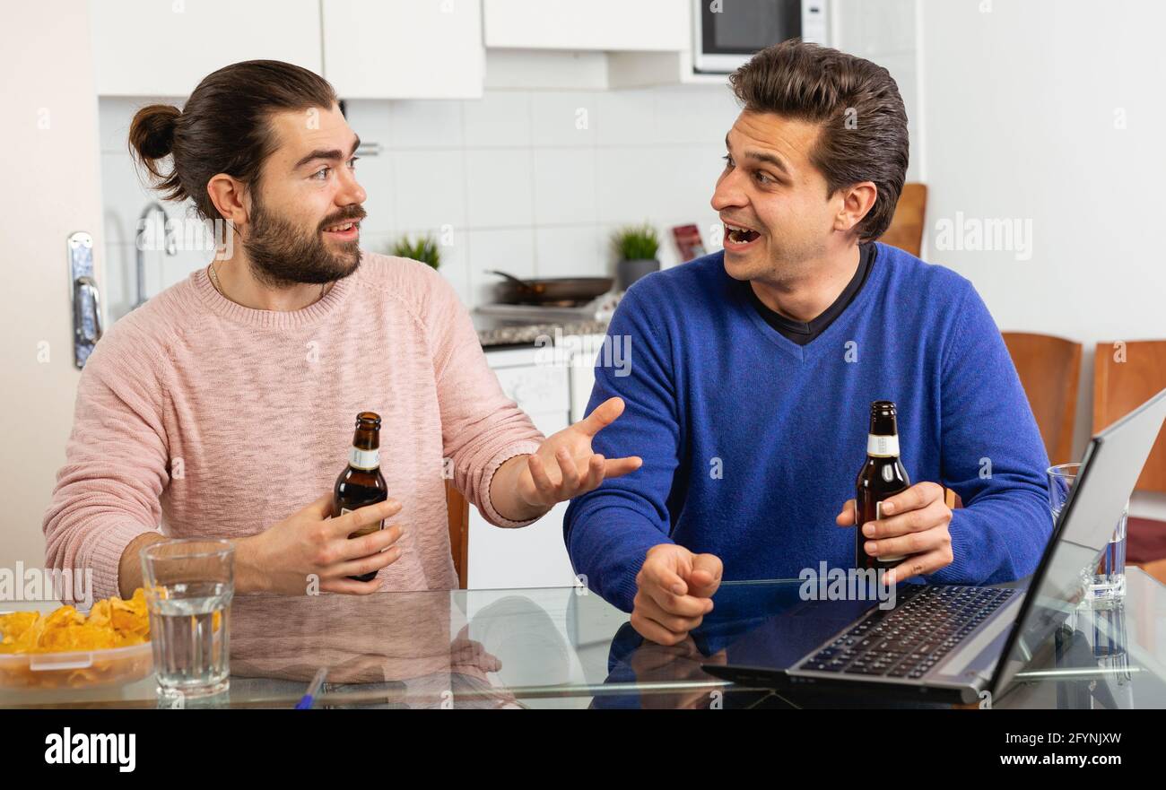 Two men friends are talking and drinking beer Stock Photo - Alamy