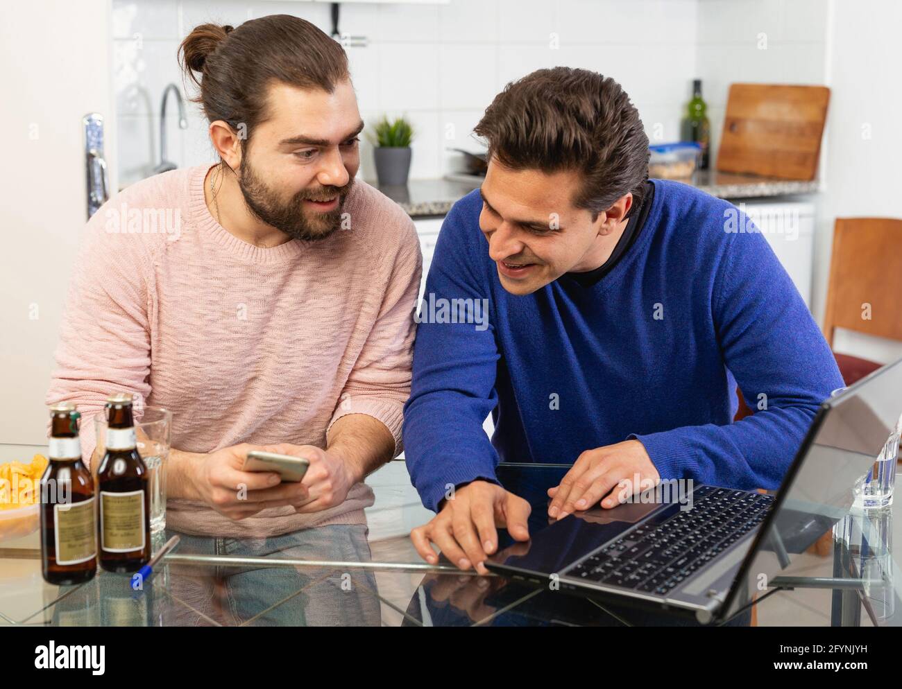 Two men friends are talking and drinking beer Stock Photo - Alamy