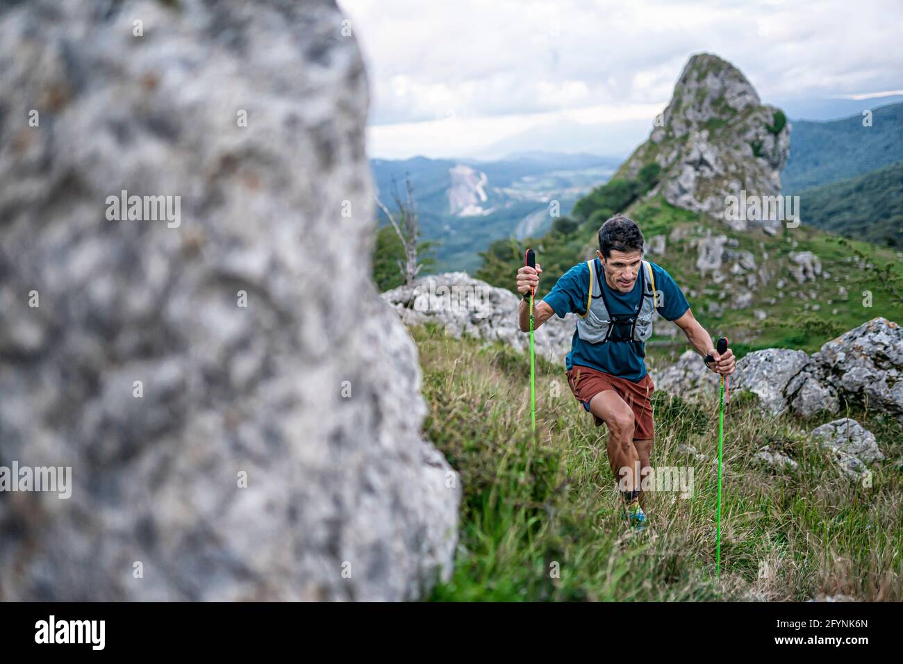 Boy running trail in a mountainous area of and full of trees Stock ...