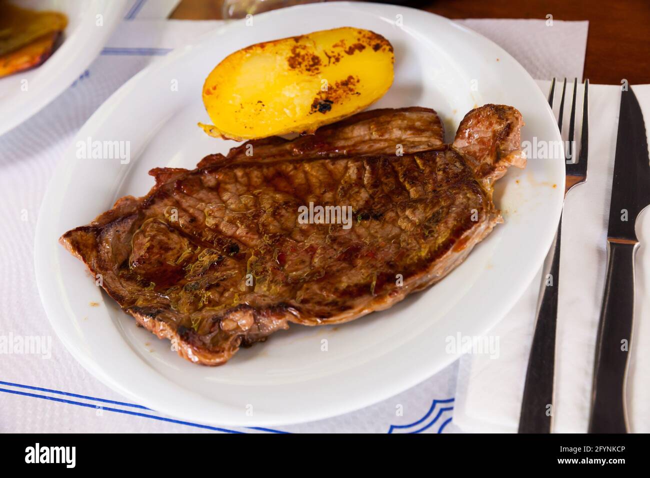 Beef steak with potatoes on a white plate Stock Photo - Alamy