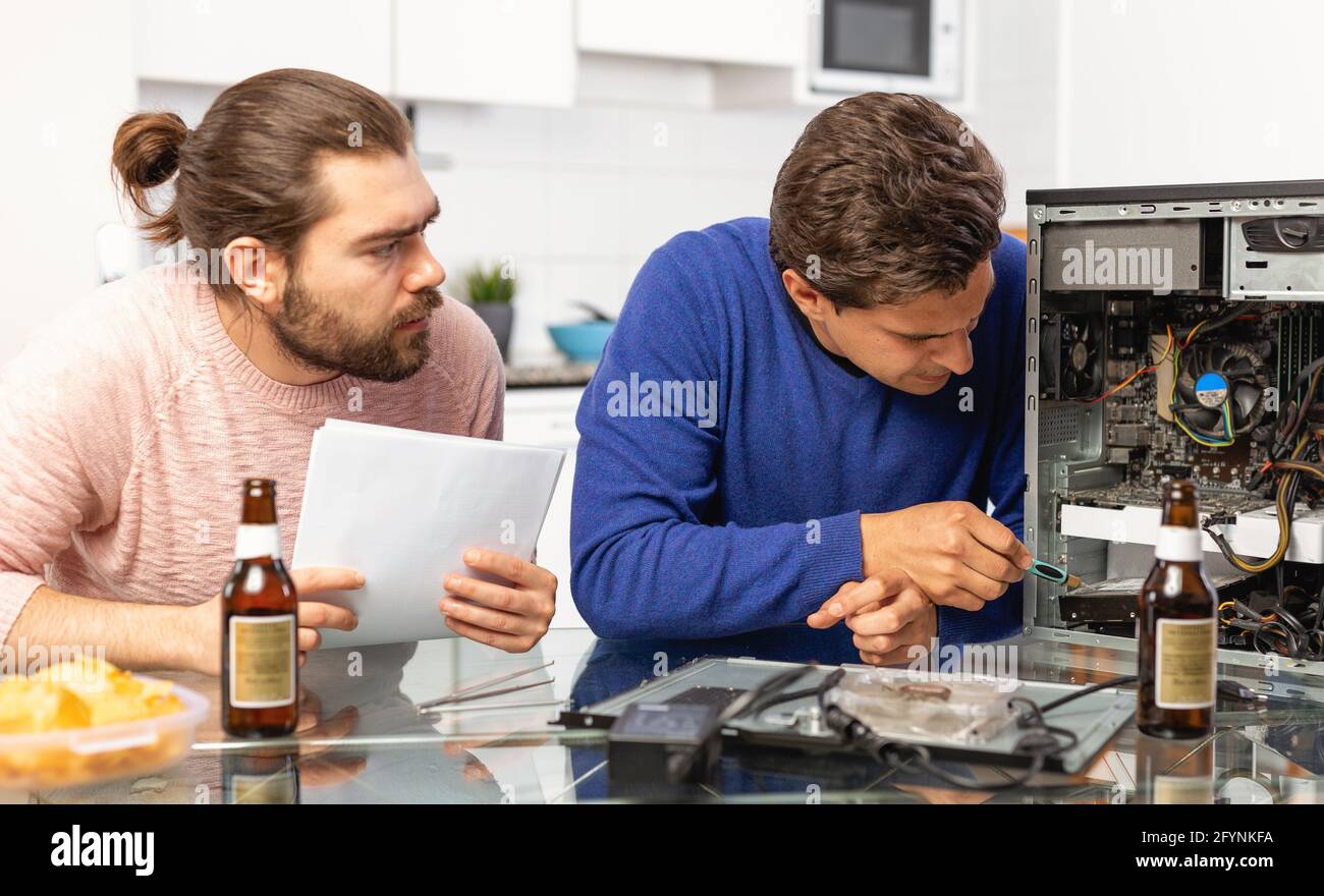 Men drink beer and repair the desktop computer Stock Photo - Alamy