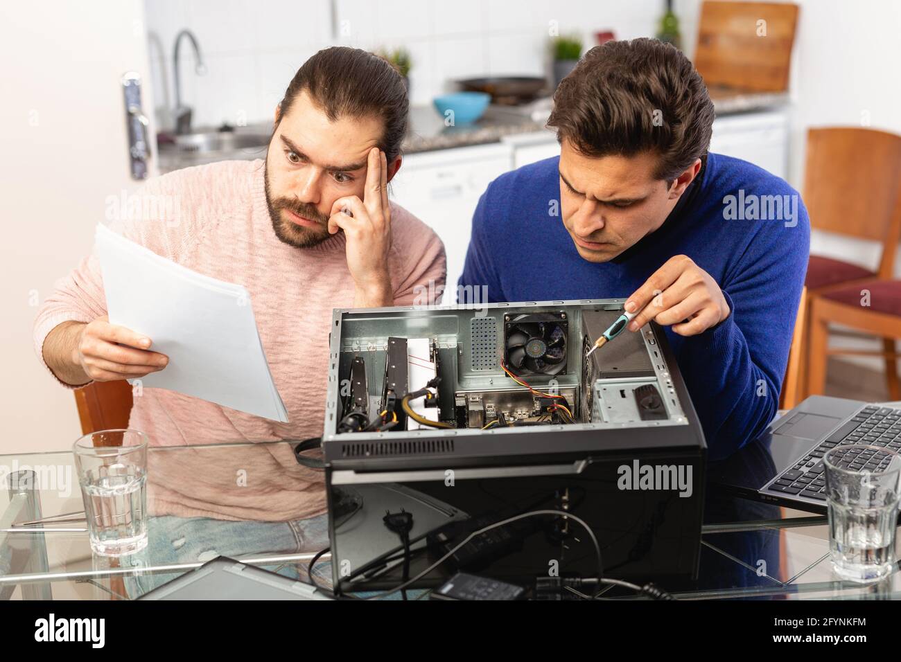 Two men are engaged in assembling a desktop computer Stock Photo - Alamy