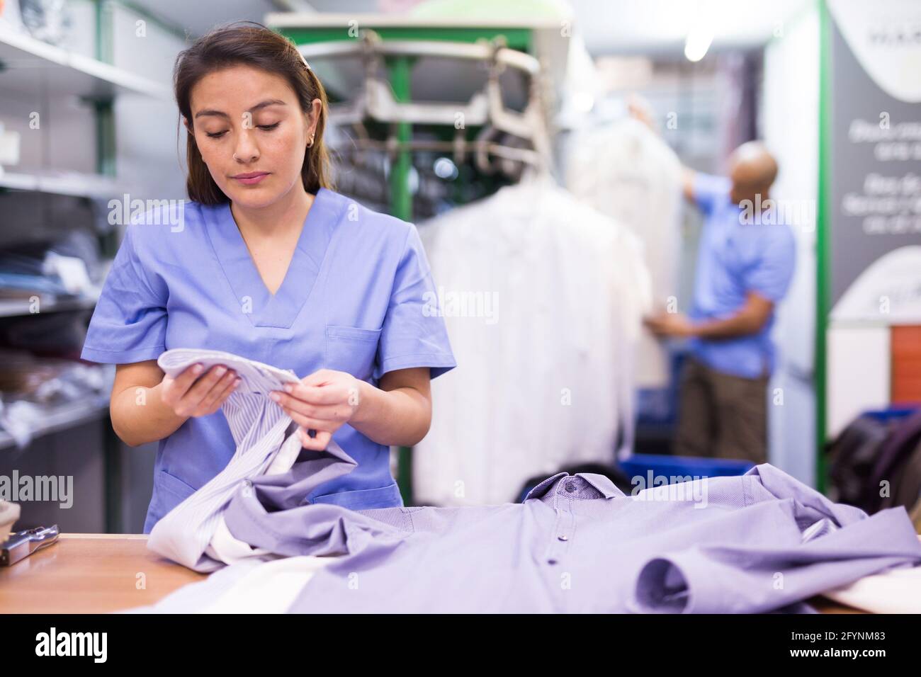 Female laundry worker checking hi-res stock photography and images - Alamy
