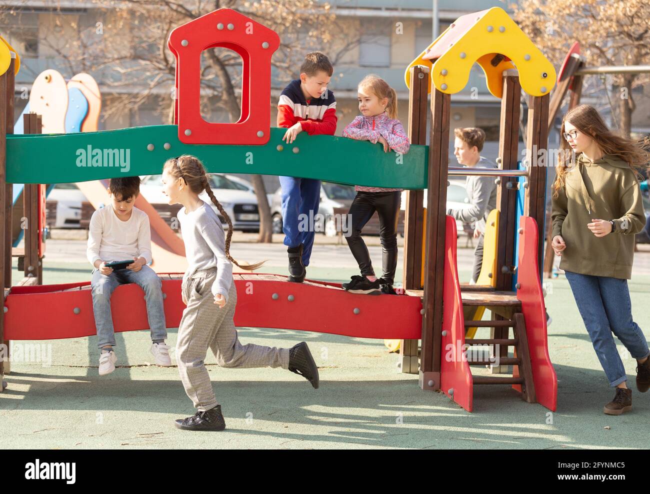 Smiling kids playing together on playground outdoors Stock Photo - Alamy