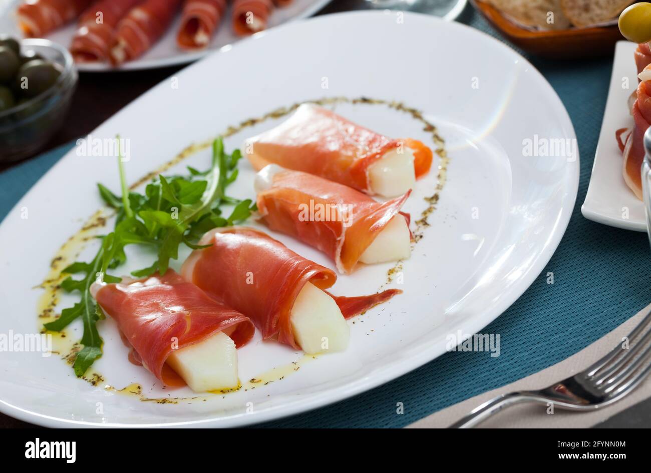 Traditional Spanish dish – jamon with slice of fresh melon Stock Photo ...