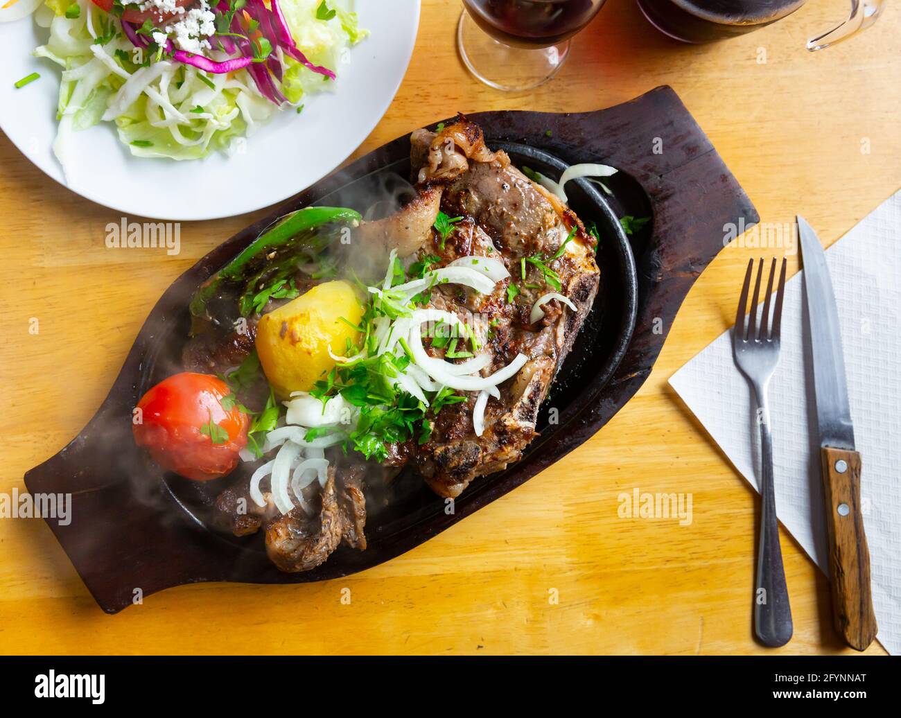 Fried beef with vegetables on a traditional ceramic plate cooked in a ...