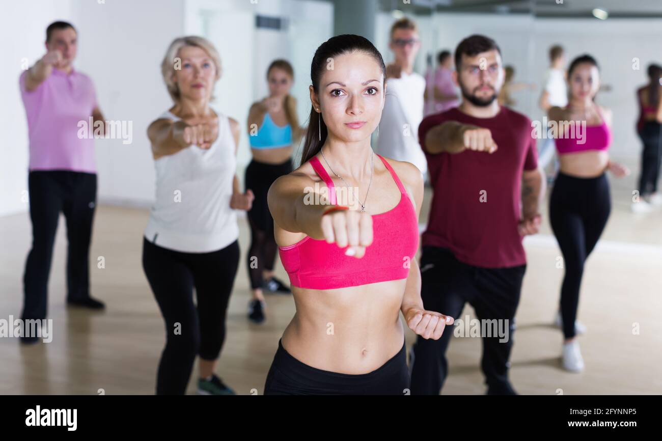 Active people of different ages practice sport dance in studio Stock ...