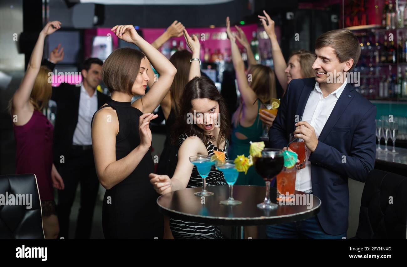 Happy positive glad colleagues dancing on corporate party with ...