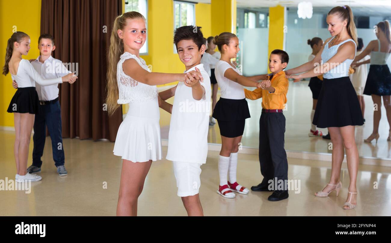 Positive children are dancing tango in class Stock Photo - Alamy