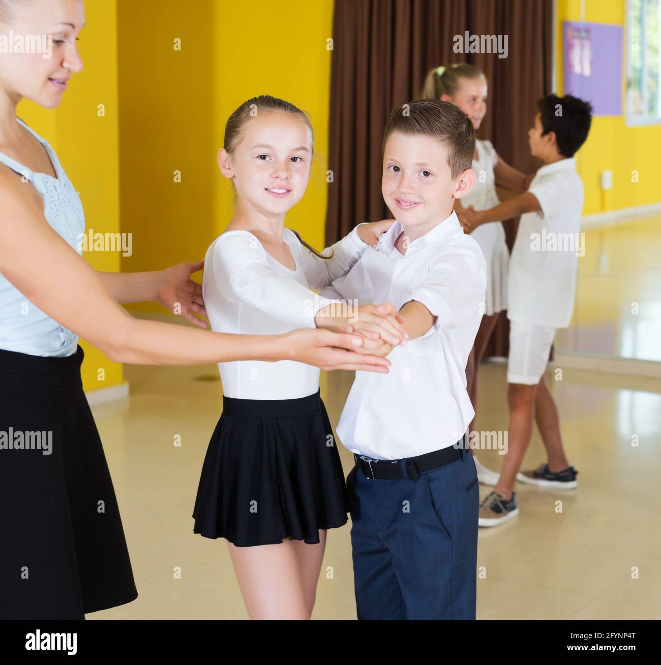 Portrait of active happy children enjoying of partner dance in class ...
