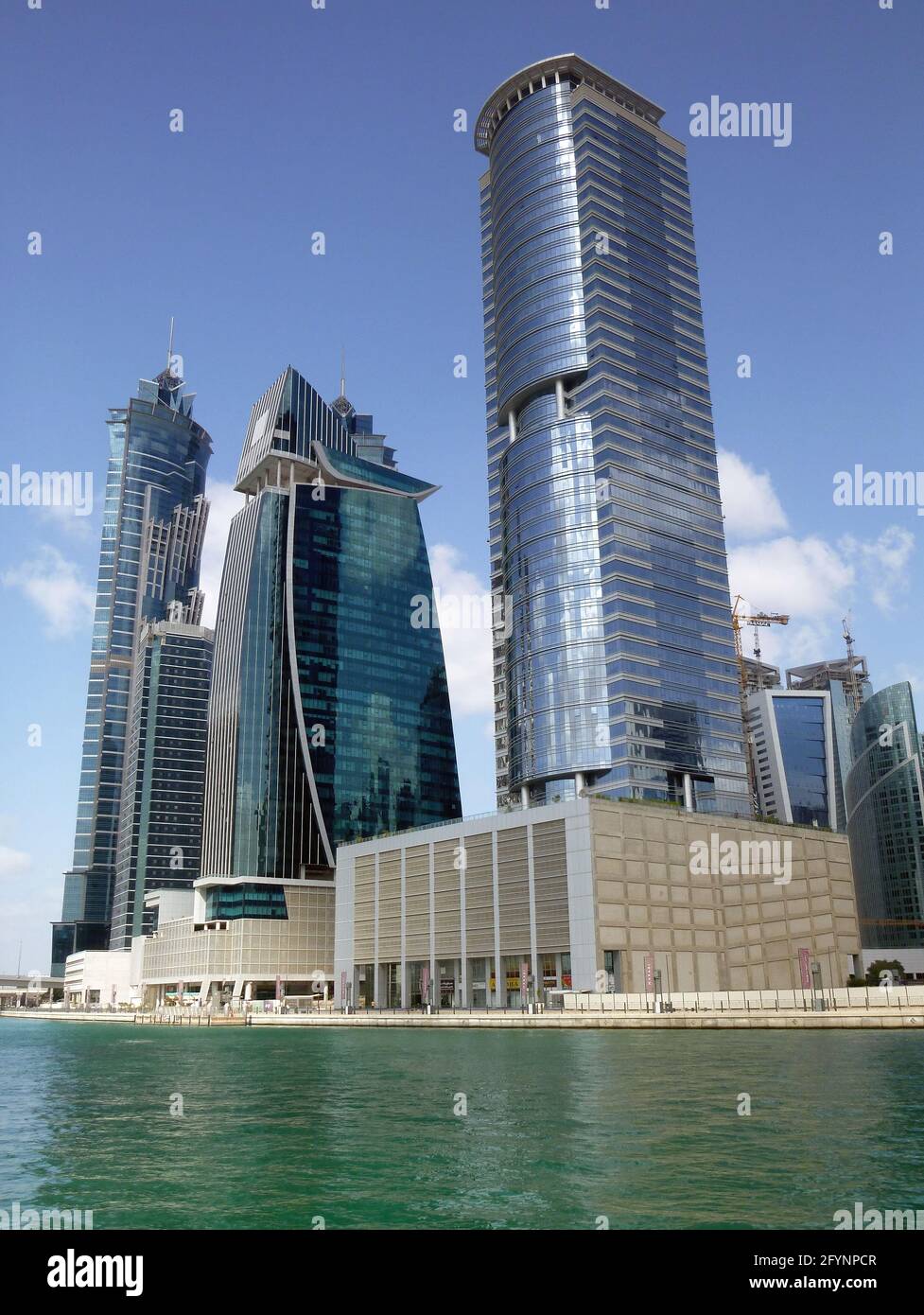 Vertical shot of high-rise buildings next to the Dubai Water Canal ...