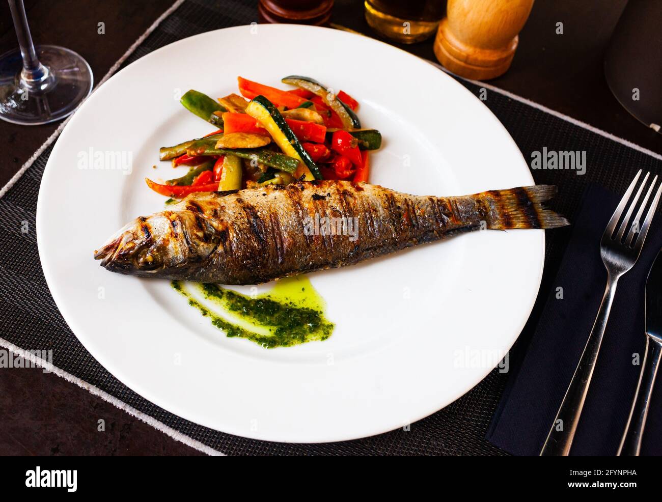 Delicious fish dish – baked sea bass with stewed vegetables Stock Photo ...