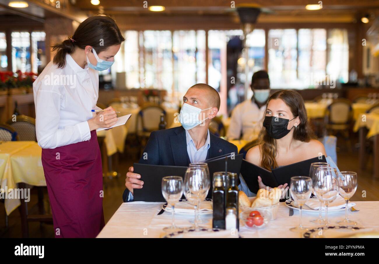 Table setting restaurant waiter mask hi-res stock photography and ...
