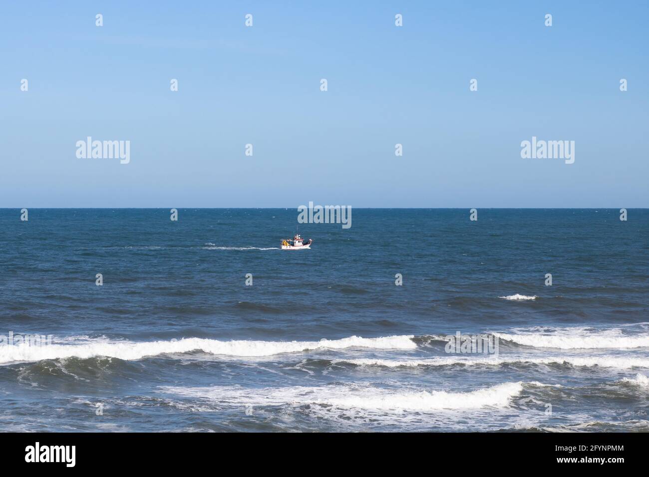 Distant fishing boat hi-res stock photography and images - Alamy