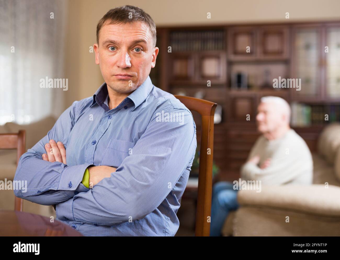 Misunderstanding and quarrel between senior father and son Stock Photo ...