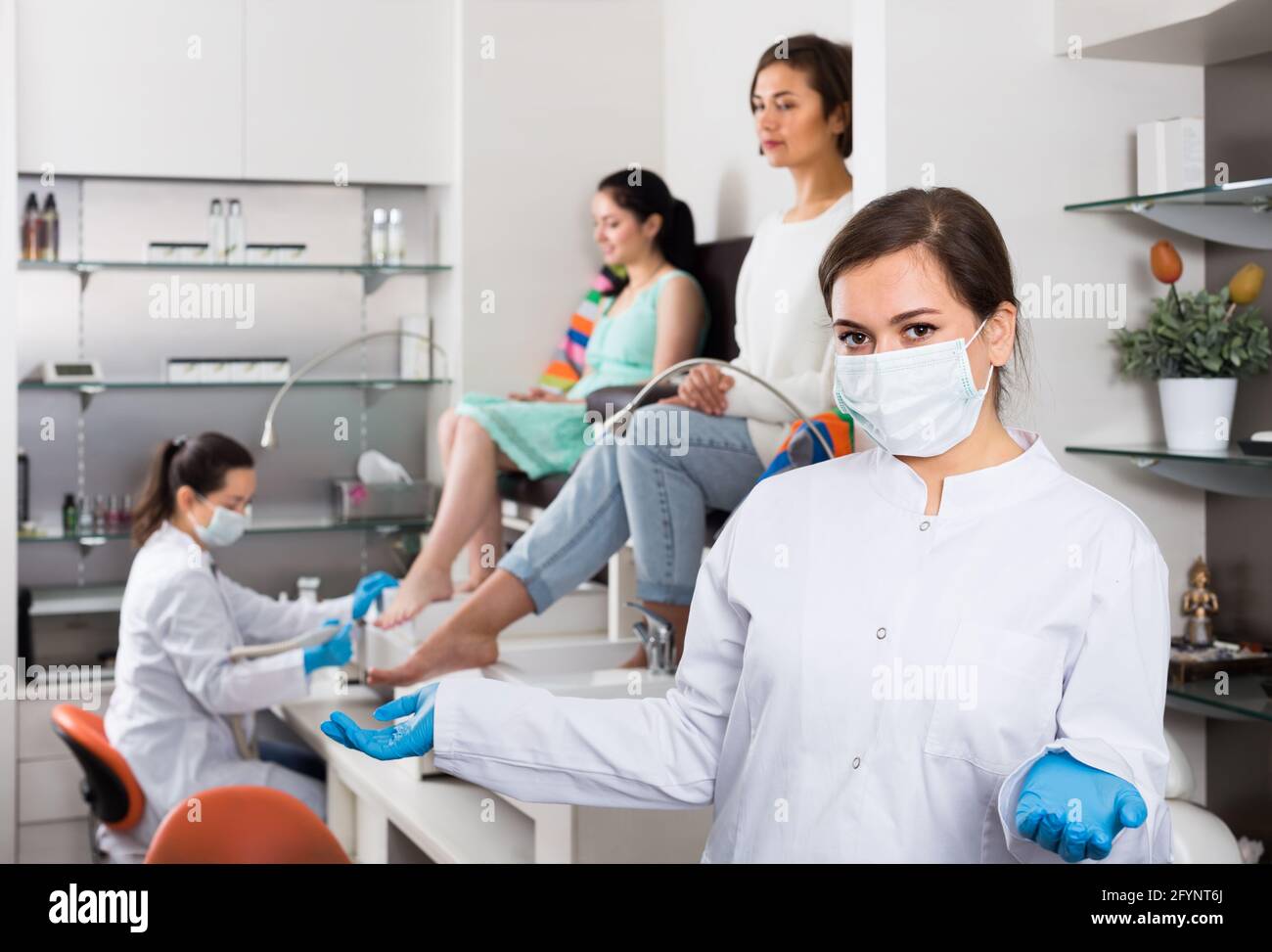 woman nail technician welcoming visitors to modern beauty salon Stock ...