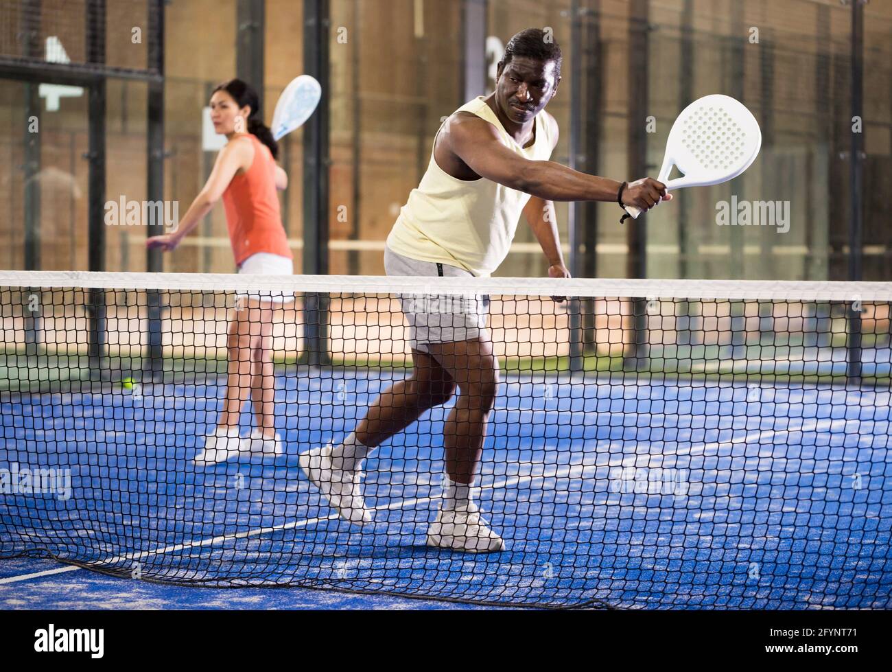 Padel tennis player posing in court Stock Photo - Alamy