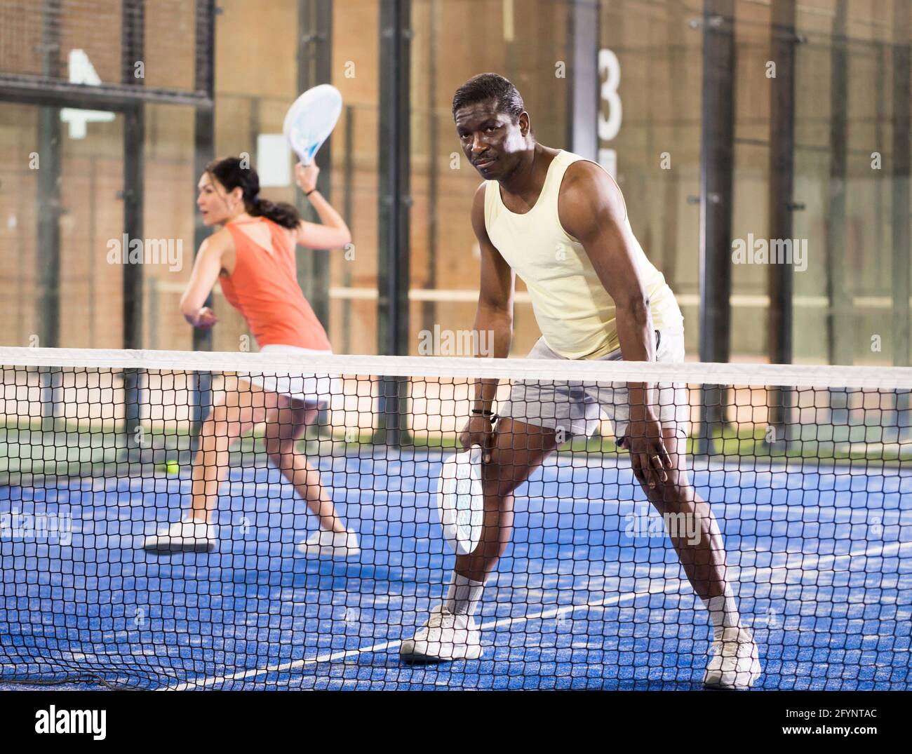 Padel tennis player posing in court Stock Photo - Alamy