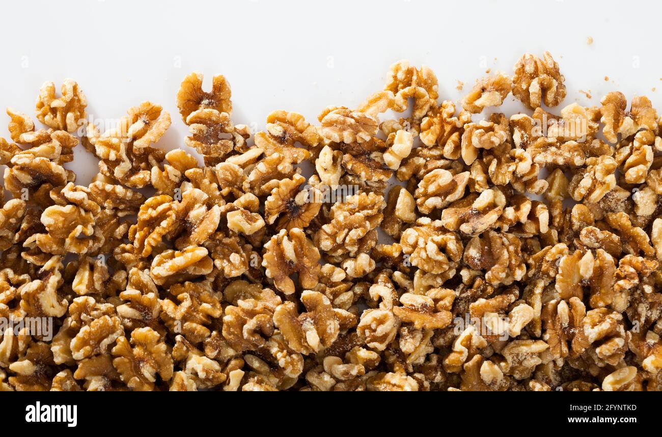 Natural background of shelled walnut kernels on white surface. Healthy ...