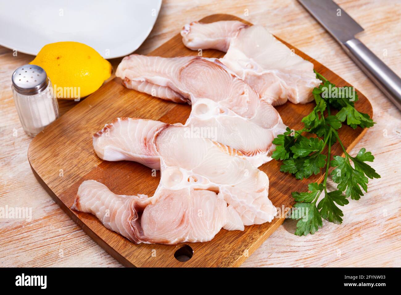 Tiger shark fillet on cutting board with lemon and parsley. Healthy ...