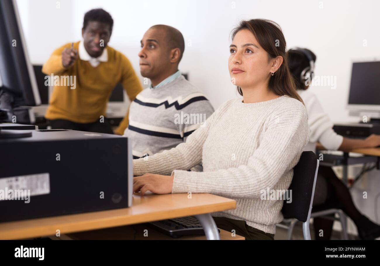 Intelligent young Latina engaged in self-learning working with computer ...