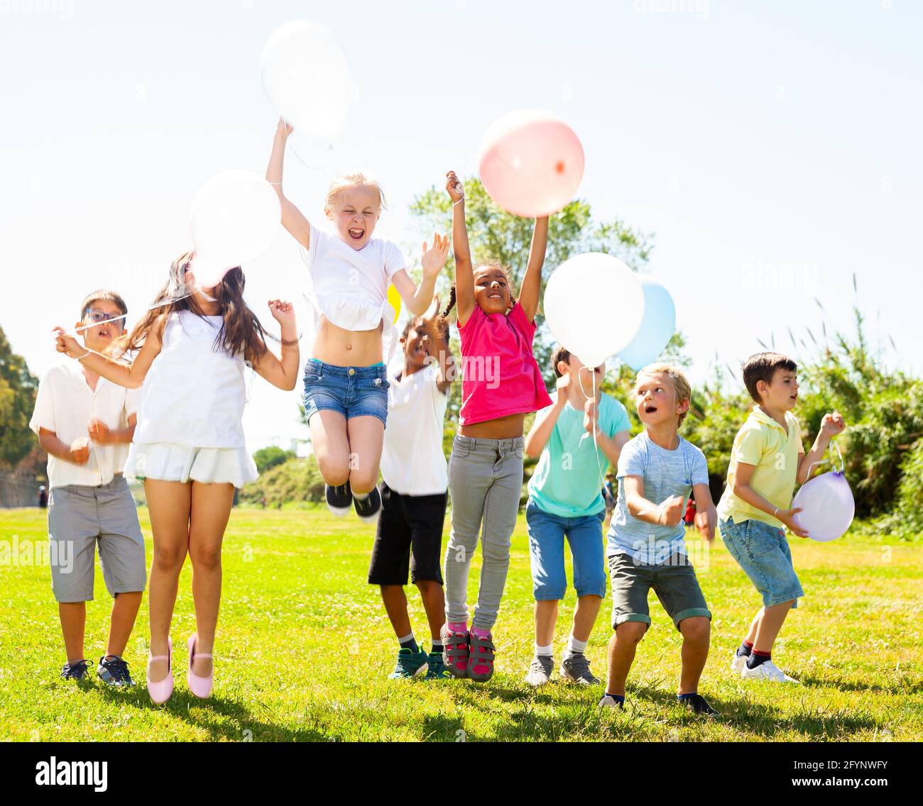 Kids playing balloons on field hi-res stock photography and images - Alamy