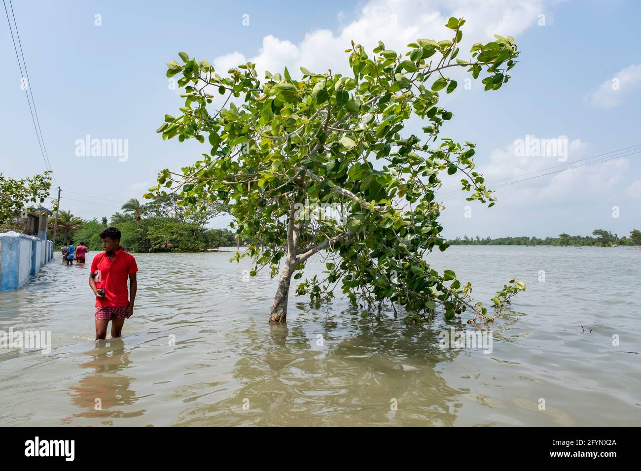 Man walking through flood water hi-res stock photography and images - Alamy