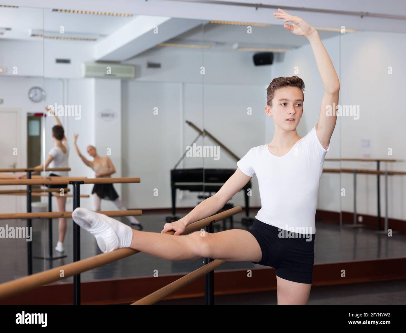 Slim young man rehearsing ballet dance in studio Stock Photo - Alamy
