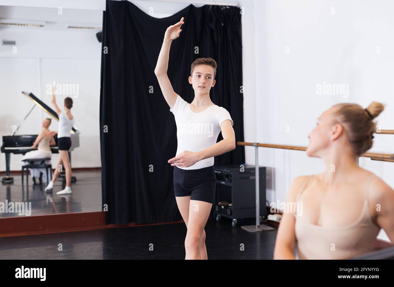 Ballet lesson in the studio. Choreographer plays the piano Stock Photo ...
