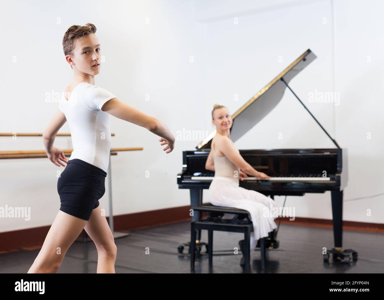 Ballet lesson in the studio. Choreographer plays the piano Stock Photo ...