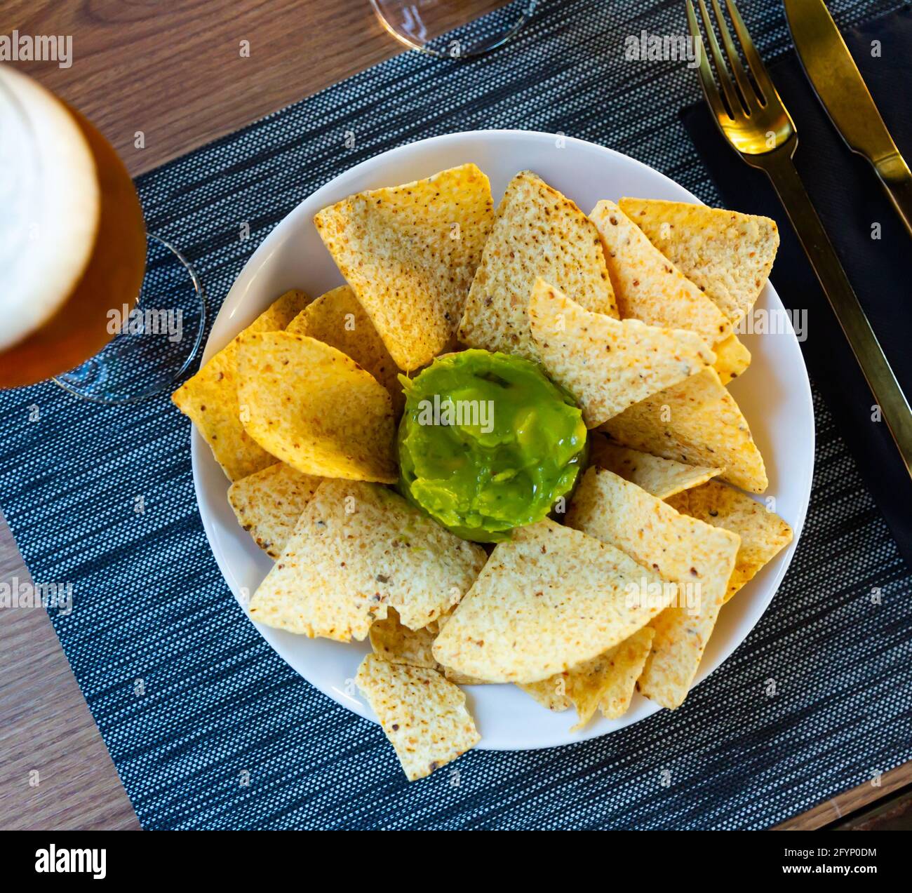 Popular Mexican Guacamole sauce with corn chips nachos Stock Photo - Alamy
