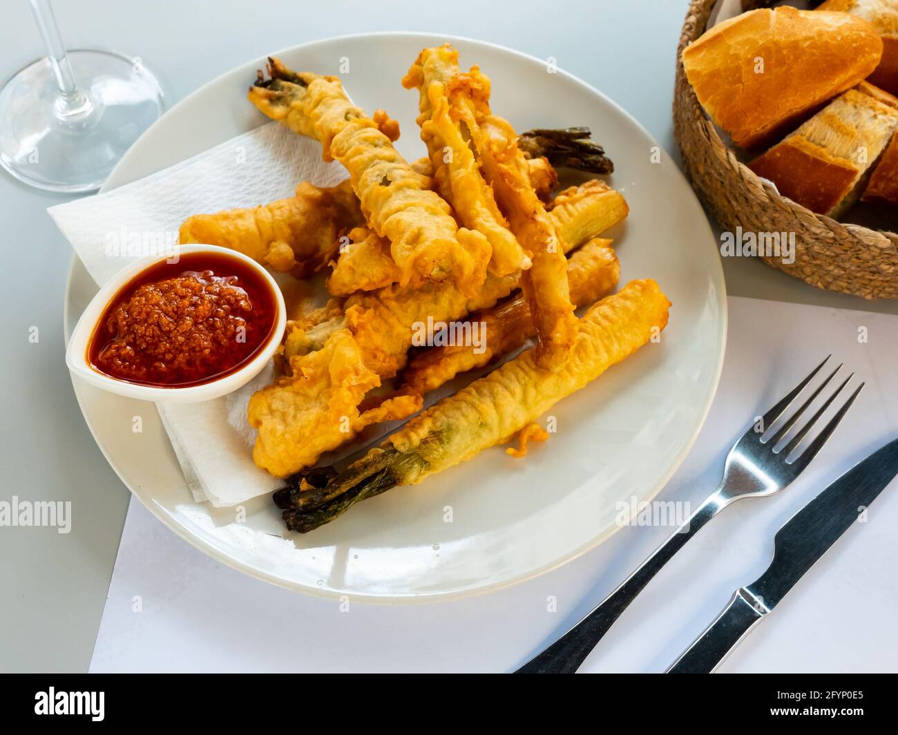 Appetizing calcots tempura traditionally served with romesco sauce ...