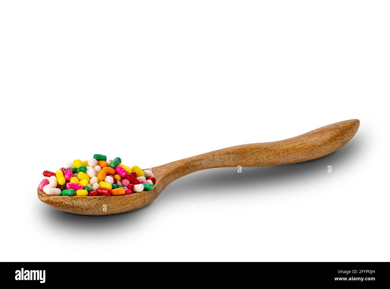 Side view of rainbow sprinkles in wooden spoon on white background with ...