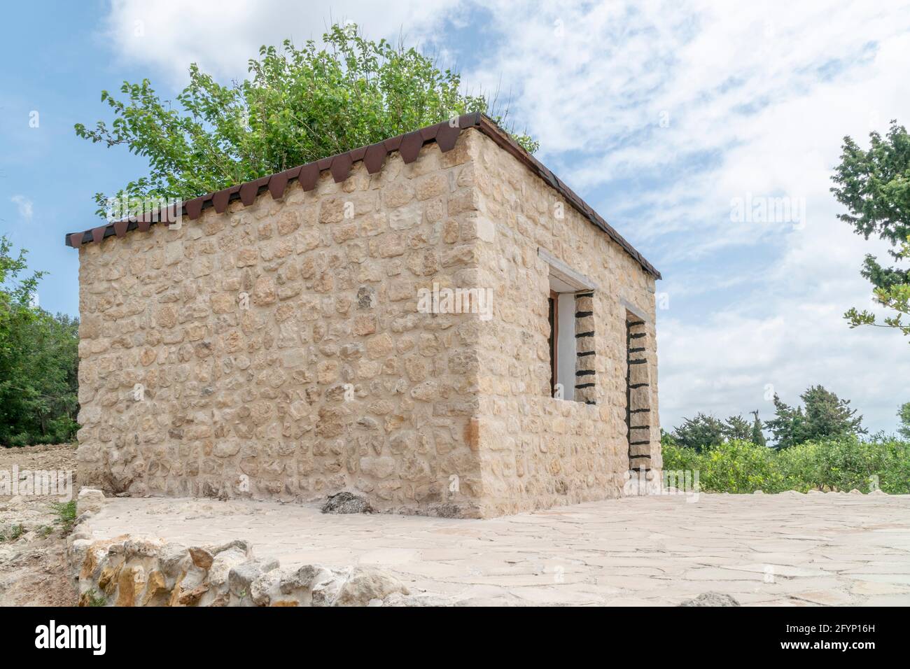 a small stone house under blue sky with copy space Stock Photo - Alamy