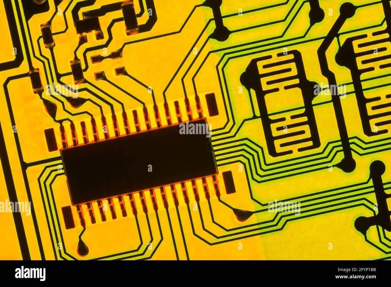 Vibrant coloured abstract macro shot of an opaque printed circuit board ...