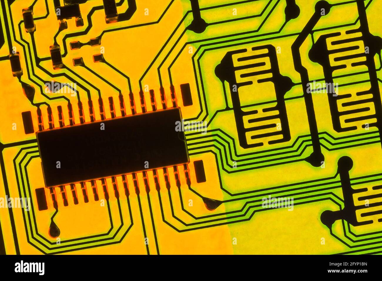 Vibrant coloured abstract macro shot of an opaque printed circuit board ...