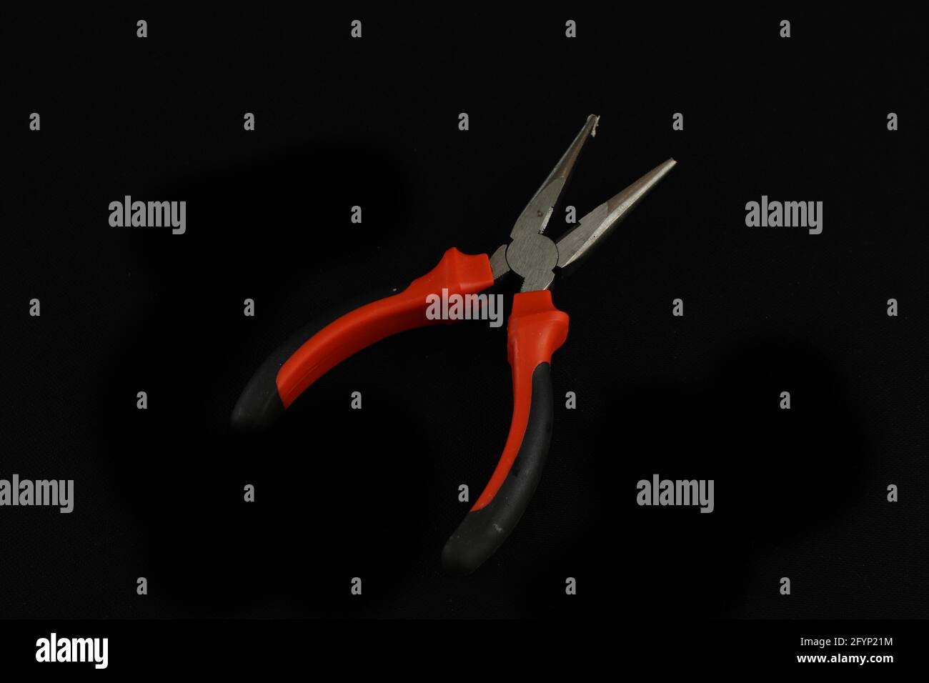 Closeup of a needle point plier on a black background Stock Photo - Alamy
