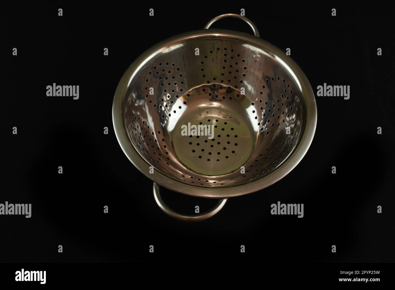 Closeup of a strainer on a black background Stock Photo - Alamy
