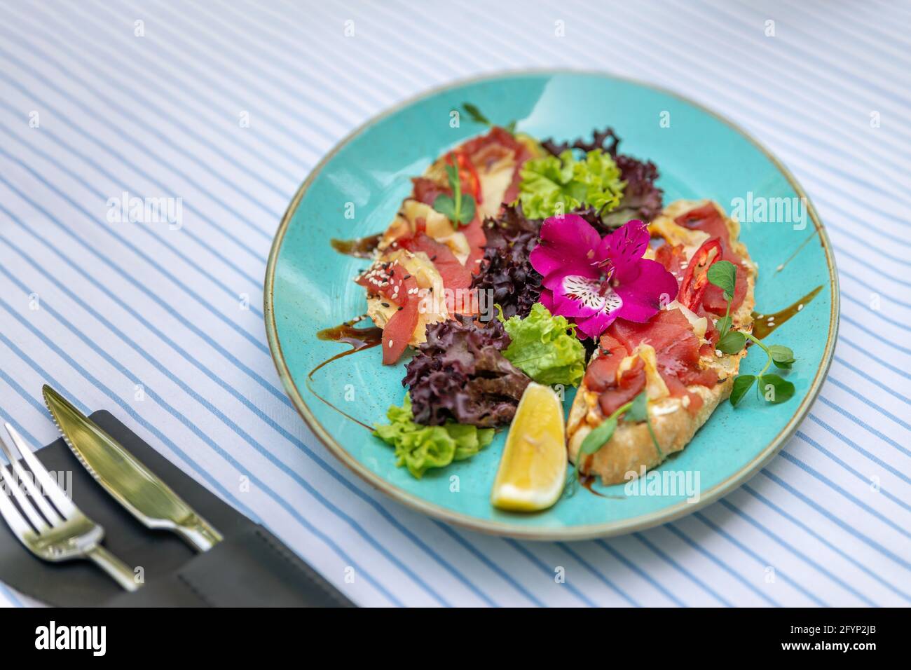 A plate with bruschetta with salmon and curd cheese. Sandwich with ...