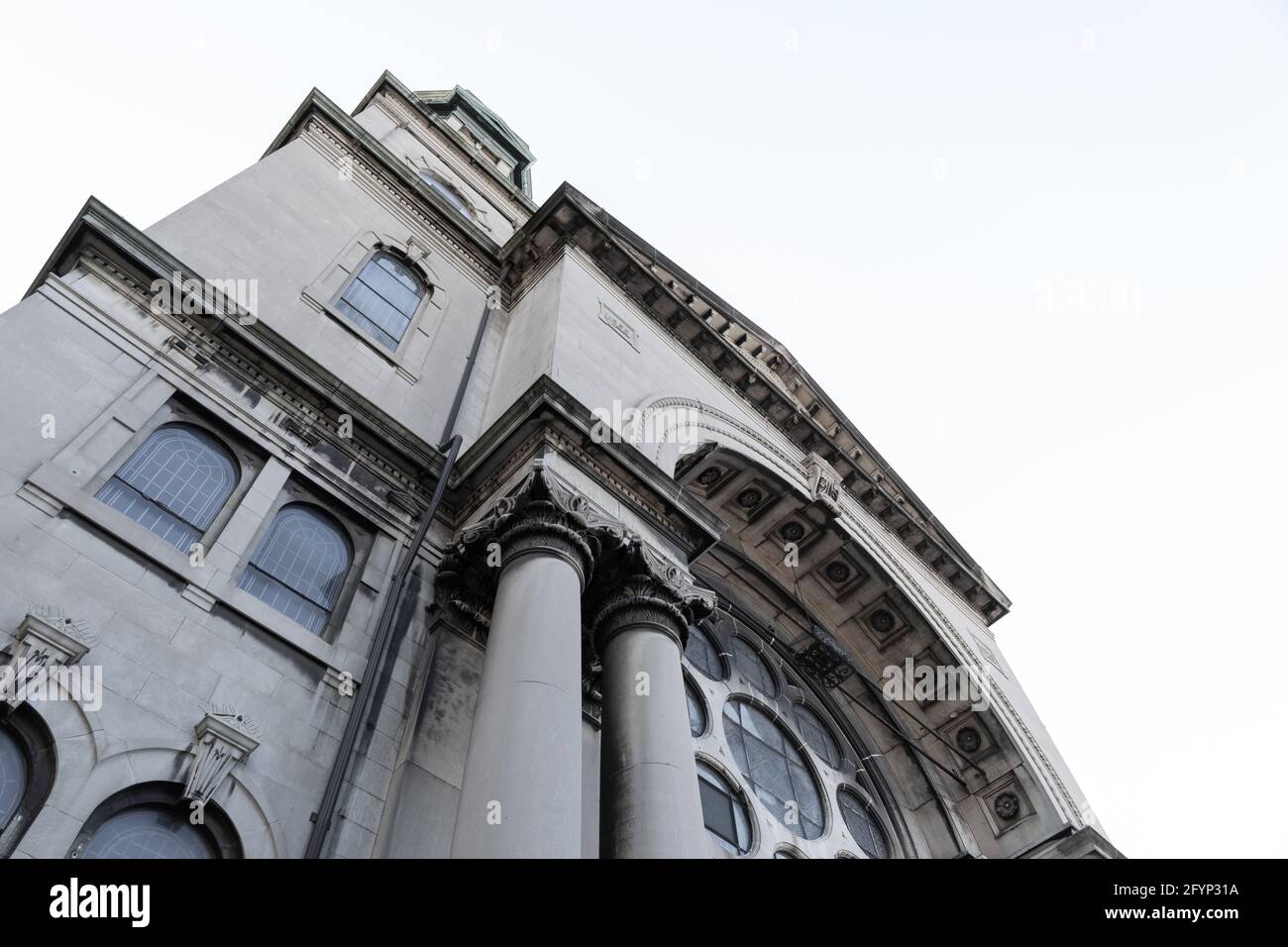 Cold gray stone church building with many architectural details and ...