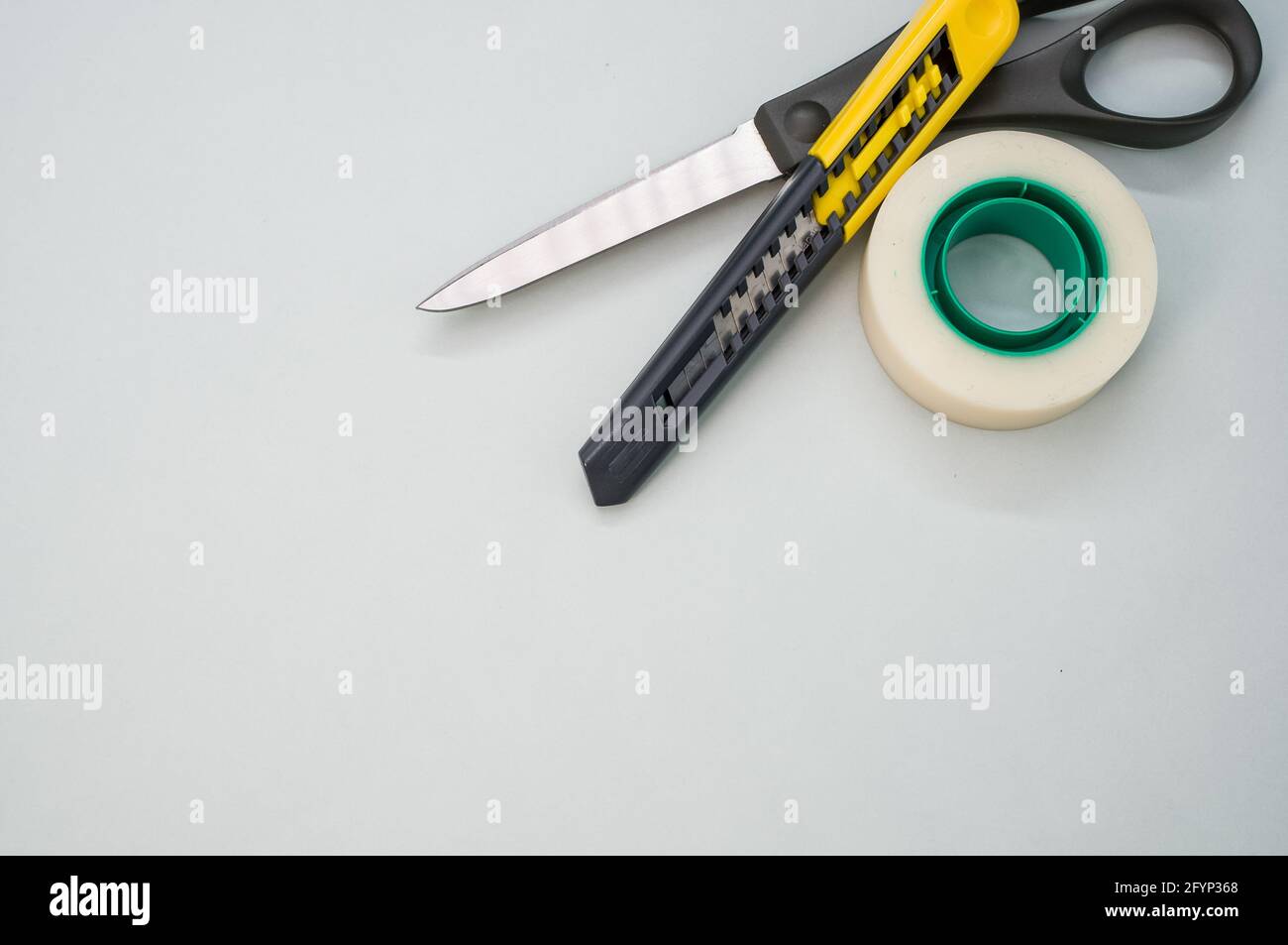 Closeup shot of scissors adhesive tape and a utility knife Stock Photo ...