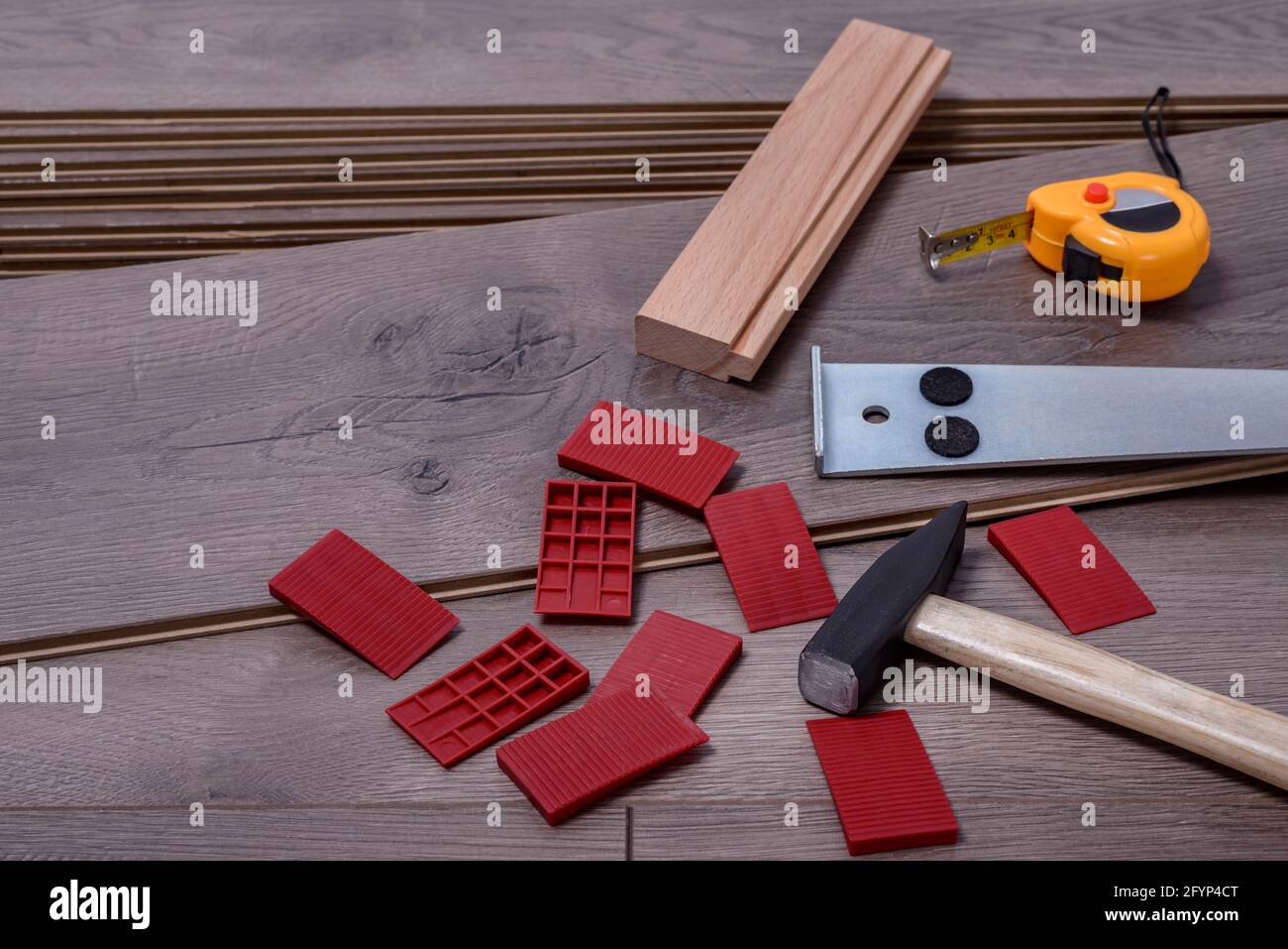 Planks of laminate floor and equipment or tools to install them, hammer ...