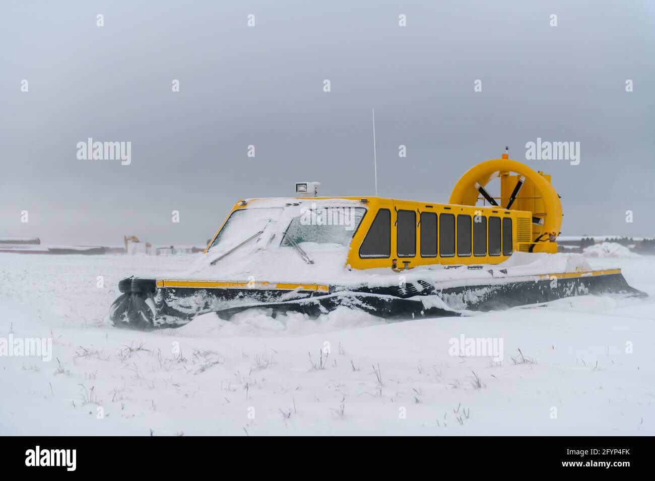 Hovercraft in winter tundra. Air cushion on the beach. Yellow hover ...